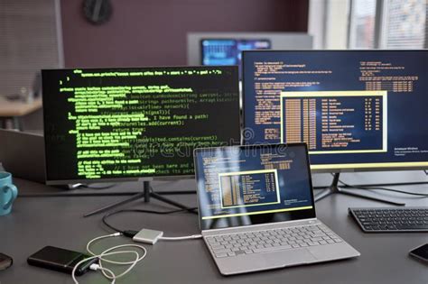 Background Image Of Computers And Laptops With Green Code Lines Stock