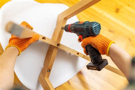 Assemble Furniture Man Assembling Chair Furniture Assembler With Drill Stock Image Image Of