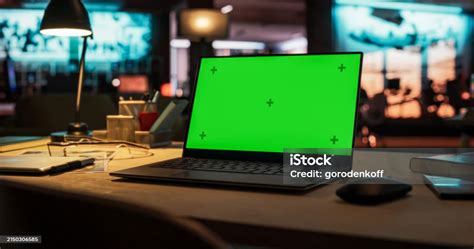 그린 스크린 크로마키 모형 디스플레이가 있는 나무 책상 위에 서 있는 노트북 컴퓨터 창의성과 혁신적인 아이디어를 촉진하는