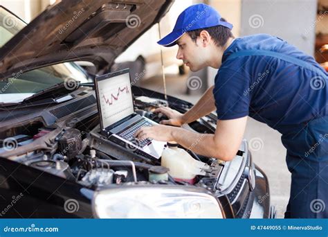 Mechanic Using A Laptop Computer To Check A Car Engine Stock Photo - Image: 47449055
