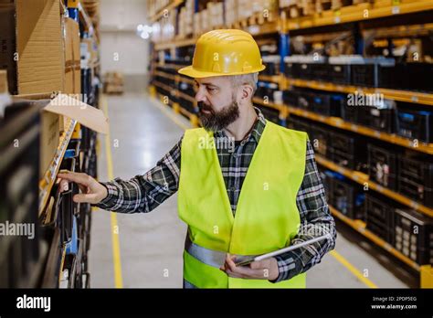 Warehouse Worker Checking Up Stuff In A Warehouse Stock Photo Alamy