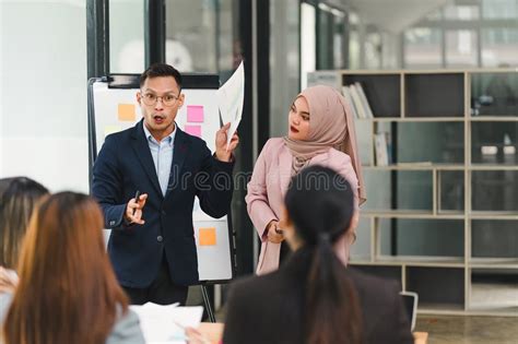 Professional Diverse Business Team Presenting And Discussing Data Charts And Graphs During