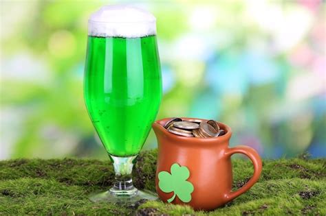 Premium Photo Glass Of Green Beer And Pitcher With Coins On Grass On