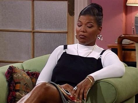 A Woman Sitting On Top Of A Green Couch