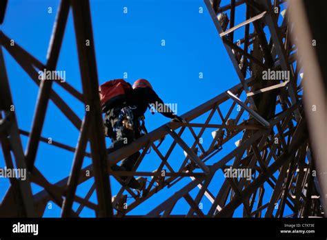 Man Climbing Eiffel Tower For Maintenance Stock Photo Alamy