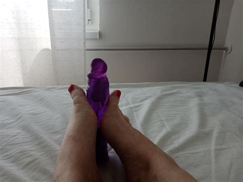 Tranny In A Lying Position Simulates A Footjob With Vibrator 5 Pics