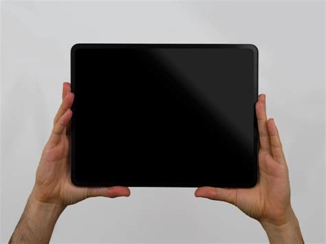Premium Photo Black Tablet Pro Screen Horizontally Held By Two Hands