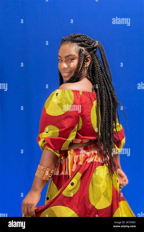Afro Brazilian Woman Dressed In African Style Standing Against Blue