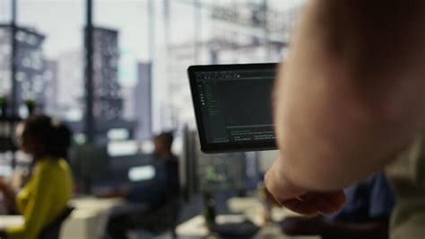 data scientist uses tablet to check on machine learning models that can