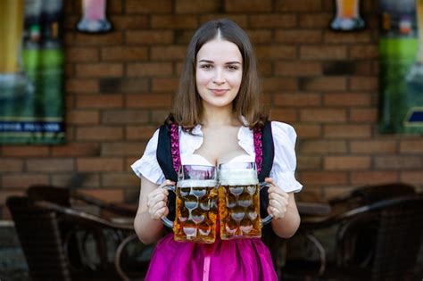 Premium Photo Sexy Russian Woman In Bavarian Dress Holding Beer Mugs