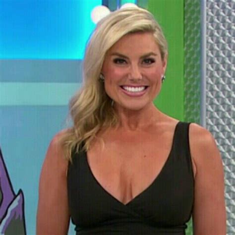 A Woman In A Black Dress Is Smiling For The Camera While Standing Next To A Cartoon Character