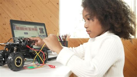 Premium Photo African Girl Build Robotic Car While Using Wires While Using Laptop Erudition