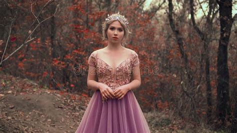 Portrait Of Blonde Princess A Woman In Royal Long Purple Dress With Bare Shoulders Looking At