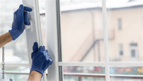 Installation Of Plastic In A Frame House The Builder Screws The Window Frame To The Slopes With