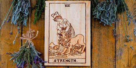The Strength Tarot Card Meanings Upright Reversed And In Love Yourtango