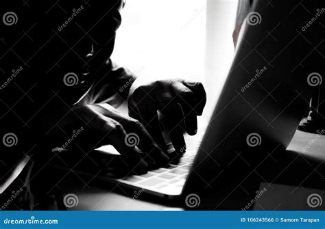 Hackers With Black Mask Using Hands Of Anonymous Typing Code On Stock