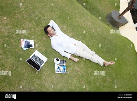 Man Lying On His Back On Grass Stock Photo Alamy