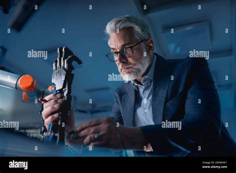 Robotics Engineer Adjusting Calibring Robotic Prosthetic Hand Concept Of Modern Technology In