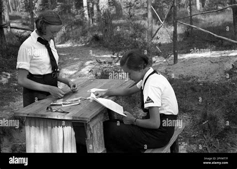 Two Girls Reading Letters In The Summer Camp Of The Bund Deutscher