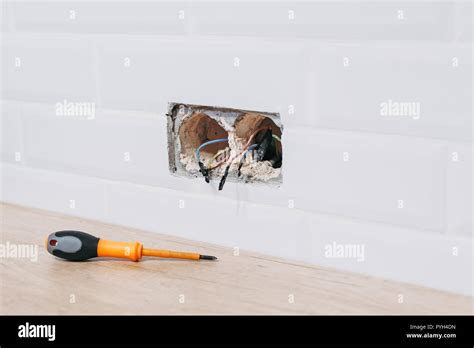 Place For Installation Of Power Socket With Protruding Wires And Screwdriver Close Up