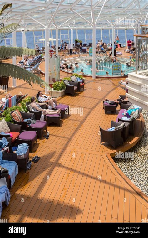 Adult Cruise Passengers Enjoying The Pool At The Solarium On The Royal