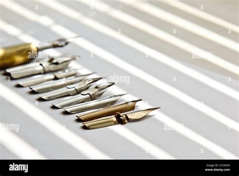 Metal Tips For The Ink Pen On A White Background In Solar Rays Stationery On White Desk Close
