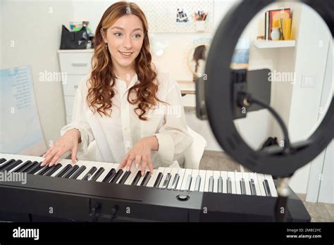 joyful synthesizer player live streaming her performance to audience