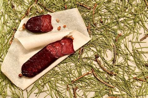 소나무 바늘로 만든 왼쪽 바닥에 소나무 싹과 양피지에 슬라이스로 잘라 알 고기로 만든 말린 소시지 가공육에 대한 스톡 사진 및 기타 이미지 Istock
