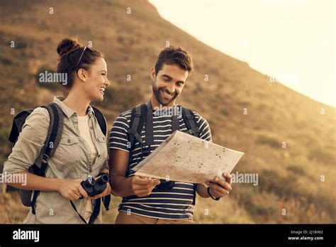 Do You Even Understand Maps Babe Shot Of A Couple Looking At A Map While Out Hiking Stock
