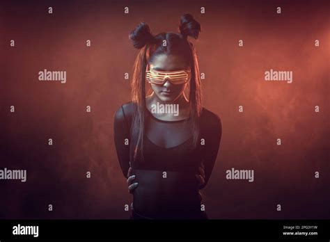 Portrait Of Beautiful Cyber Model Woman Posing Wearing Led Glasses On Head With Neon Light In A