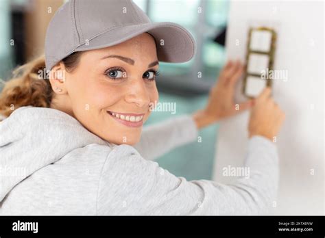 Lady Installing A Triple Lightswitch Stock Photo Alamy