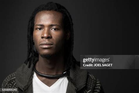 Senegalese Artist Alassane Kone Poses During A Photo Session At The