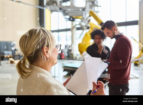 engineers collaborating on robot programming in a modern industrial