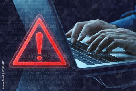 Security Alert Of Computer Exclamation Icon And Laptop Close Up Of Hands Typing Stock Photo