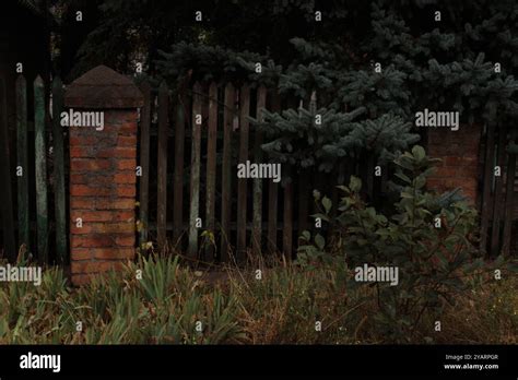A Wooden Fence With Brick Columns Looks Elegant Combining The Natural