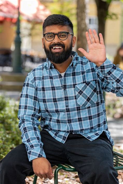 Indian Man Smiling Friendly At Camera Waving Hands Hello Hi Greeting Or Goodbye In City