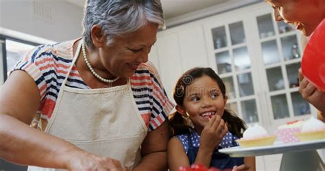 Girl Eating A Cherry While Making Cupcakes With Mother And Granny 4k