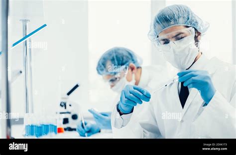 Close Up Group Of Scientists Sitting At A Laboratory Table Stock Photo Alamy
