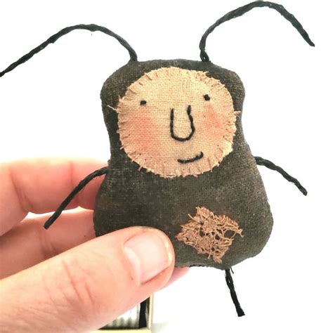 primitive bed bug in a bed with candle holder handmade stuffed toys