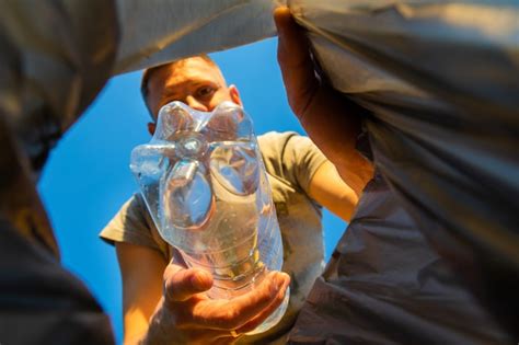 Premium Photo Man Throws Out Trash In Nature