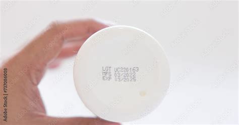Close Up Of Medicine Or Vitamin Bottle With Production Date And Expiration Date Reading The