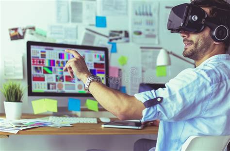Young Male Software Programmer Testing A New App With 3d Virtual Reality Glasses In Office