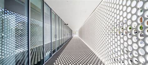 Perforated Cladding Unifies Scobs Barcelona Marina Buildings Facade