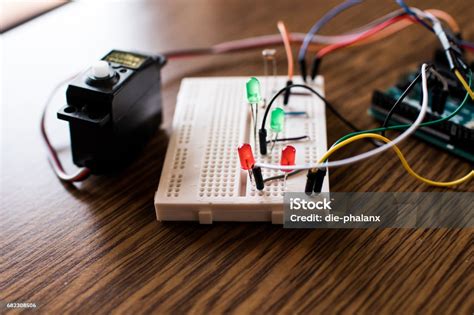 breadboard with led photoresistor resistance and servomotor connected to a opensource hardware