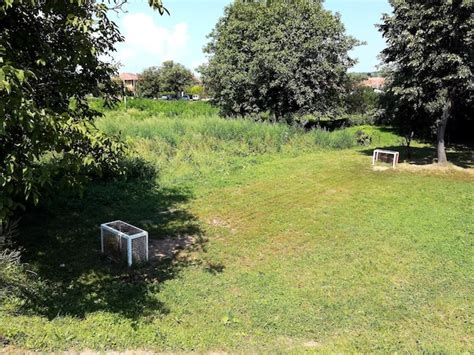 Premium Photo Built Structure On Field Against Trees