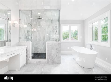 A Large Luxurious Bathroom With A Stand Alone Tub White Vanity And A Glass Stand Up Shower