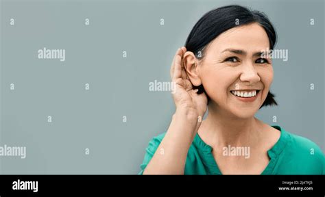 Mature Woman Listening Sound With Hand Near Ear For Hearing Check Up Hearing Test Concept Stock