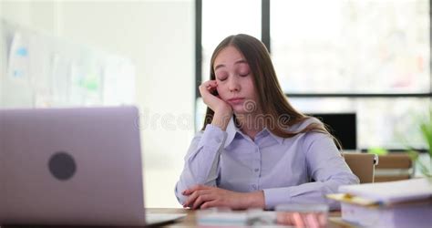 Tired Young Female Intern Student Sitting At Workplace With Eyes Closed