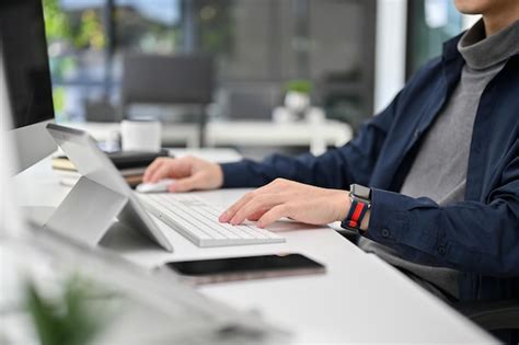 Premium Photo Cropped Asian Male Developer Or Programmer Working At Her Desk Typing On Keyboard