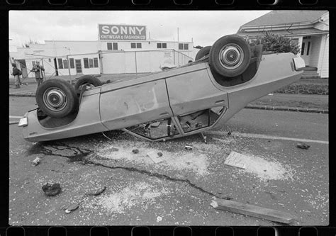 Car Upside Down In Street In Front Of Sonny Knitwear Building